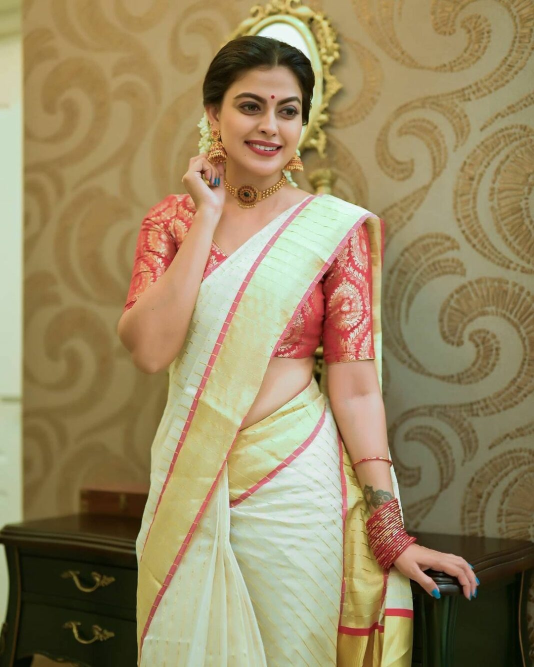 Anusree Nair looks divine in an ivory set saree with red border!